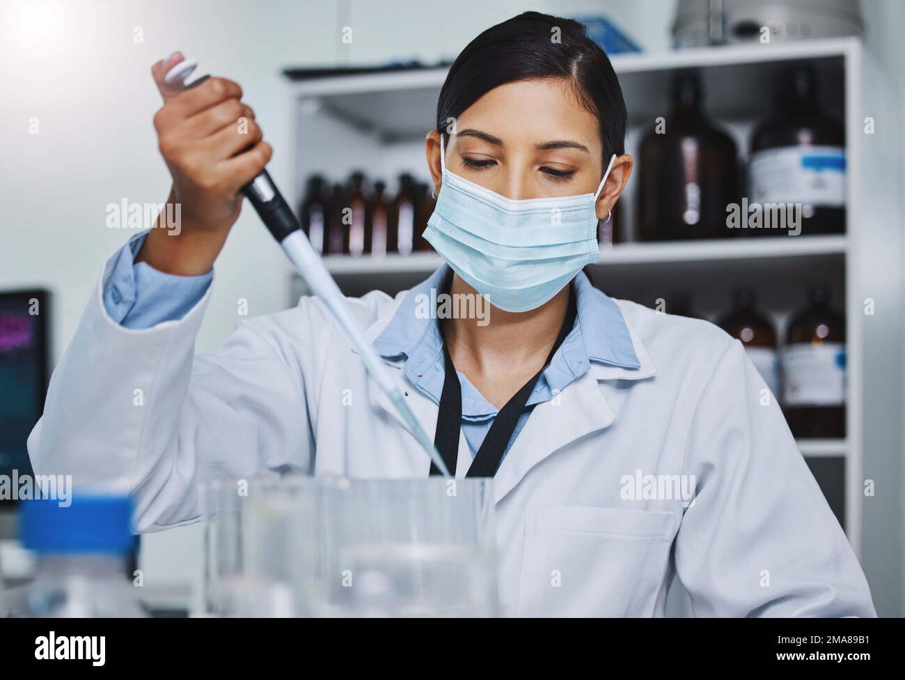 Working hard to make new discoveries. a young female researcher working ...