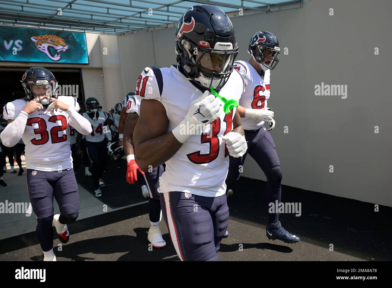 Houston Texans running back Dameon Pierce (31) runs to the field before ...