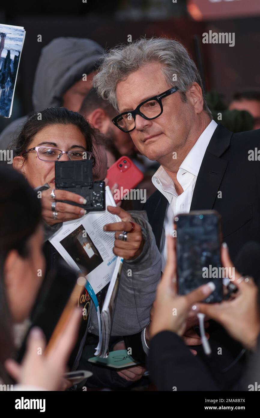 Colin Firth poses for a selfie photograph with a fan upon arrival for ...