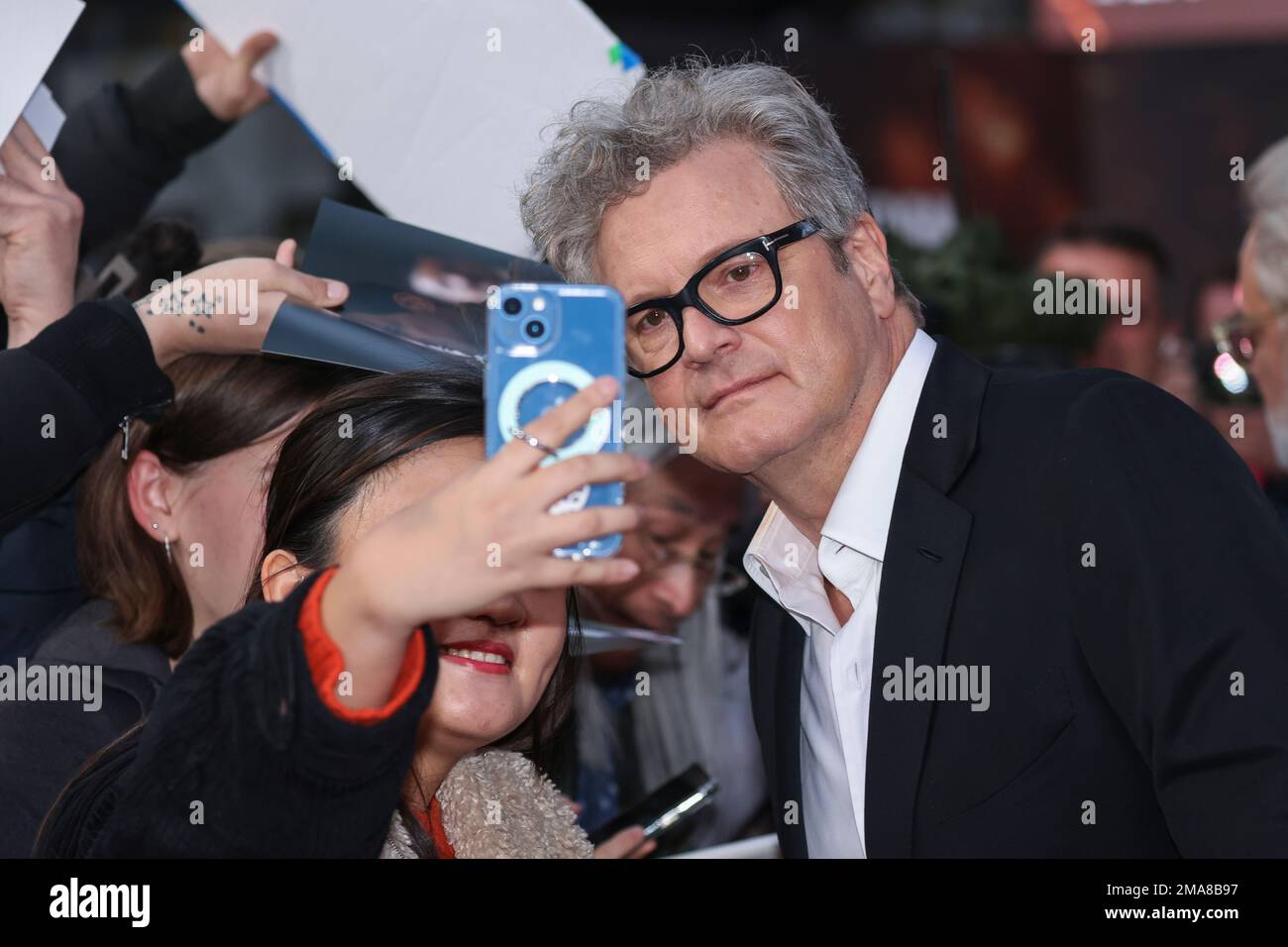 Colin Firth poses for a selfie photograph with a fan upon arrival for ...