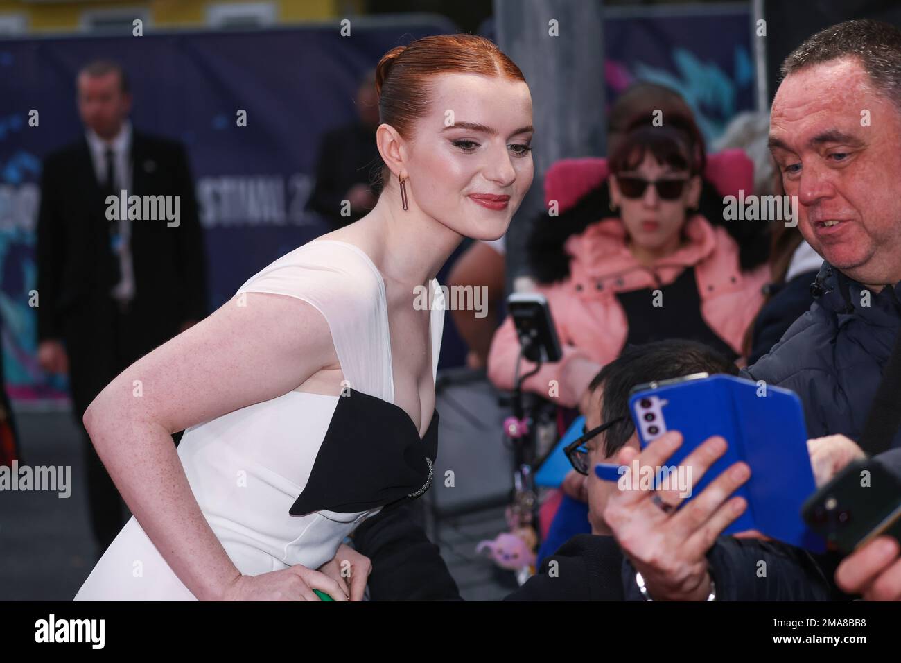 Hannah Onslow poses for a photograph with a fan upon arrival for the ...