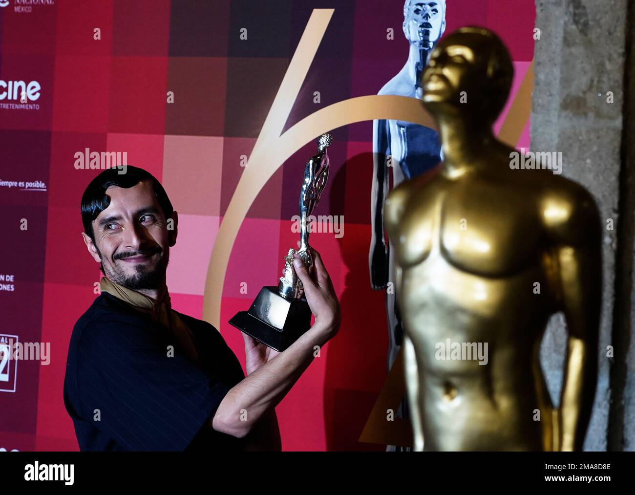 Raul Briones holds his award for best male actor for his role in the ...