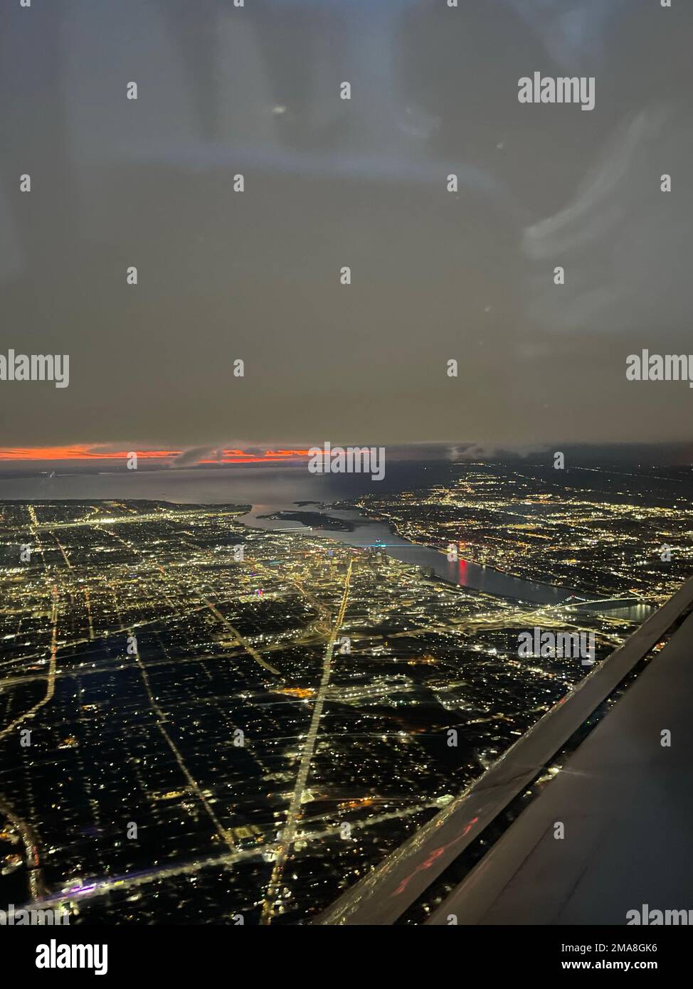 A vertical aerial view of the illuminated skyline of Detroit through a ...