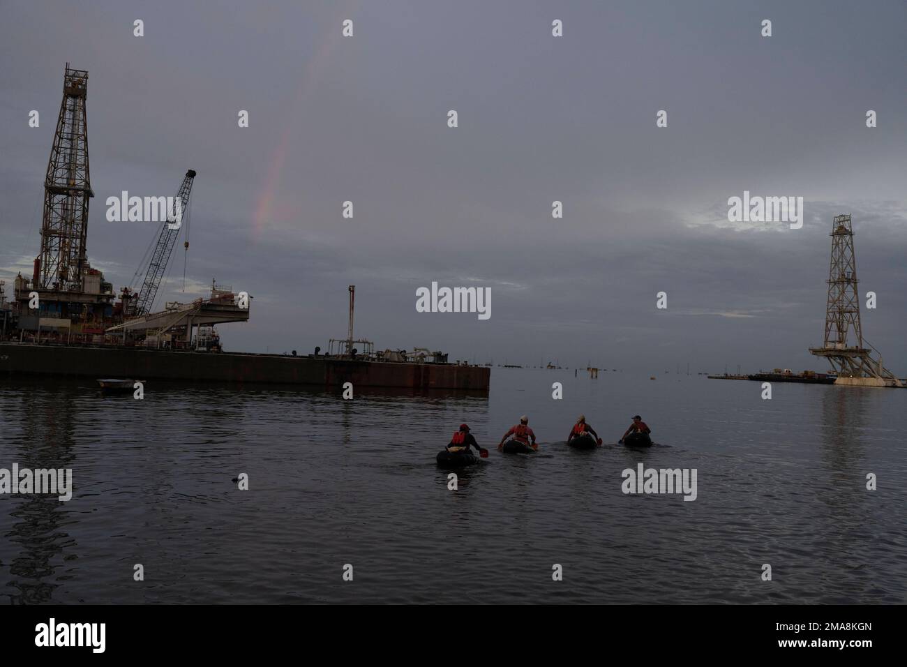 Men float on inner tubes from truck tires as they head out to fish on ...