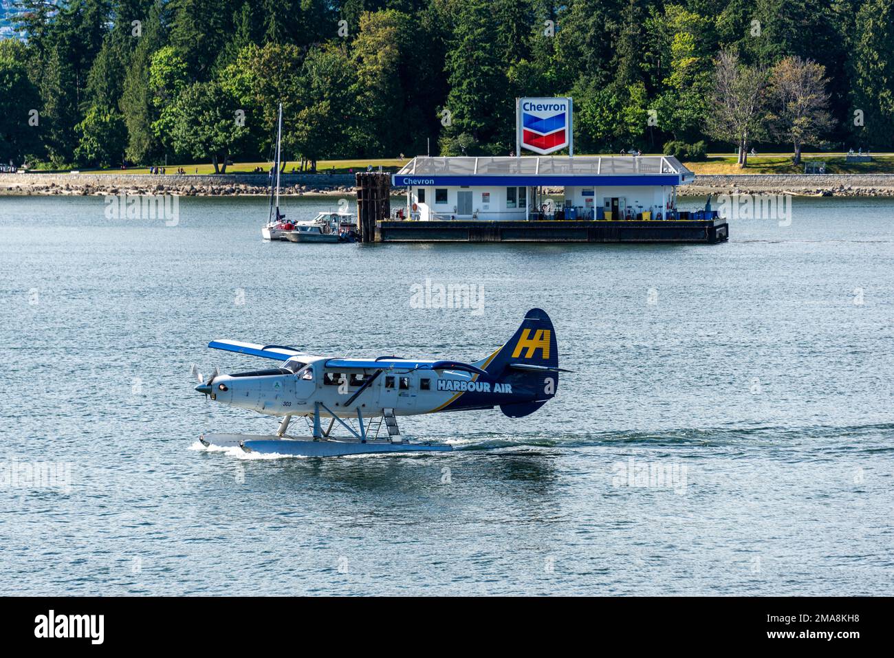 A scenic view of a seaplane seen taking off from the coast of Vancouver ...