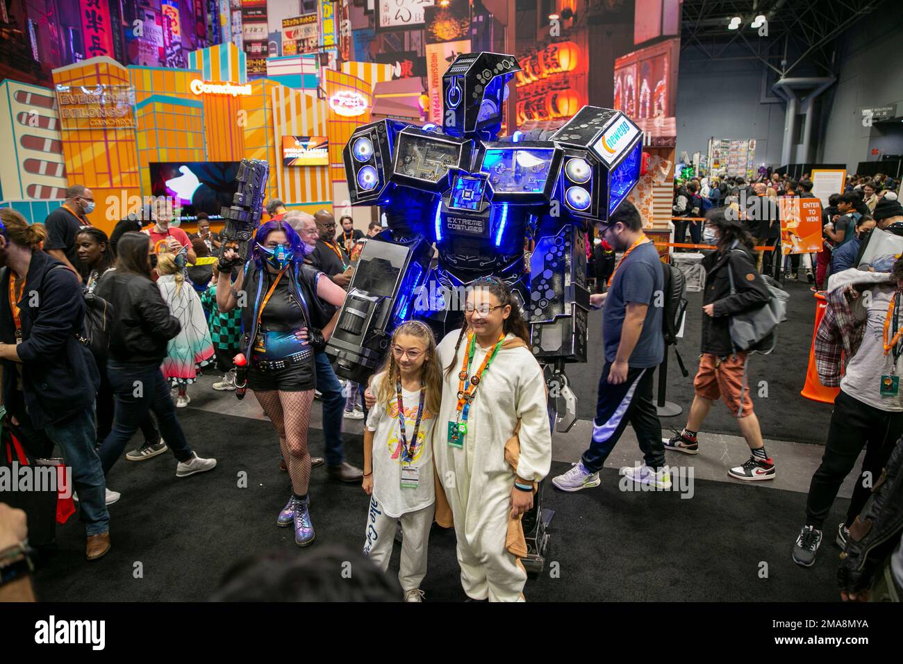 A cosplayer in a giant robot costume poses for photos during New York ...