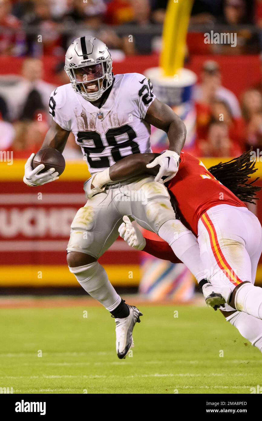 Las Vegas Raiders running back Josh Jacobs (28) is tackled by Kansas ...