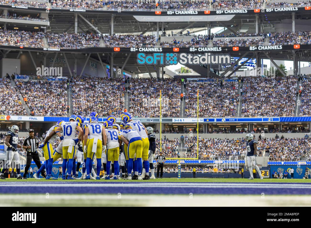 The Los Angeles Rams huddle against the Dallas Cowboys in an NFL ...