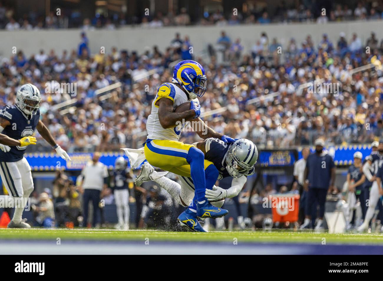Running back (3) Cam Akers of the Los Angeles Rams stiff arms (2 ...