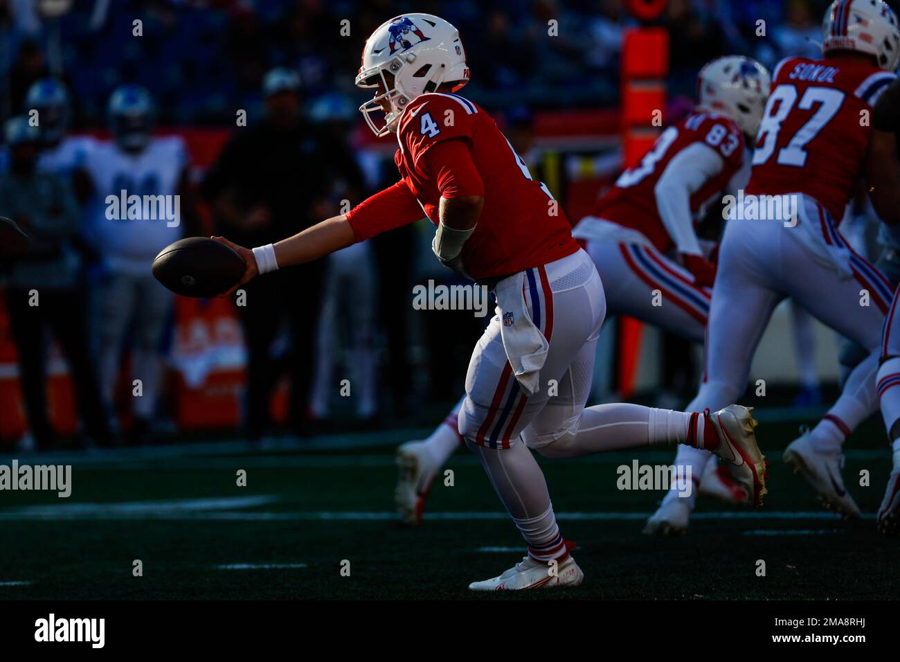 New England Patriots quarterback Bailey Zappe (4) hands off the ball ...