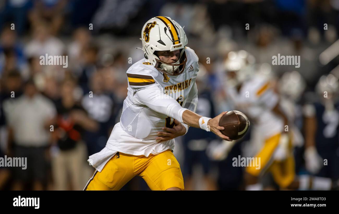 Wyoming Cowboys quarterback Andrew Peasley (6) looks to hand the ball ...
