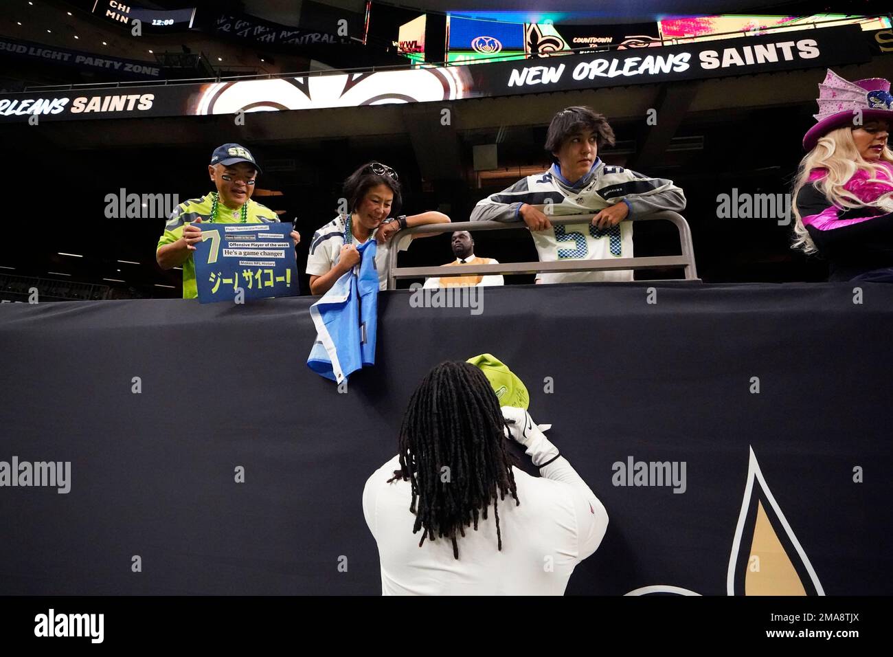 Seattle Seahawks defensive tackle Myles Adams signs autographs for fans ...