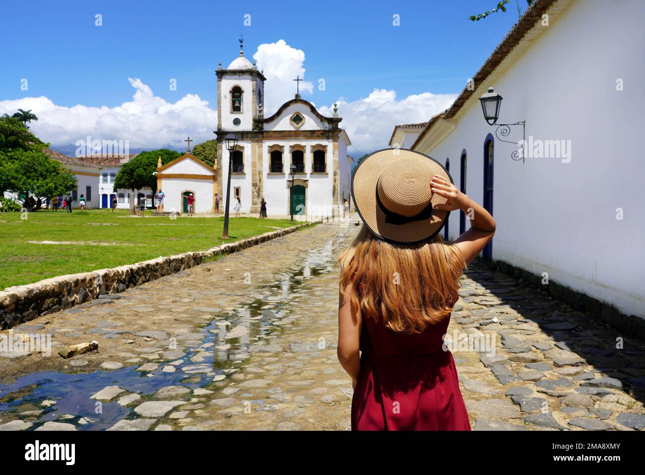 Tourism in Paraty, Brazil. Girl walking in the historic town of Paraty ...