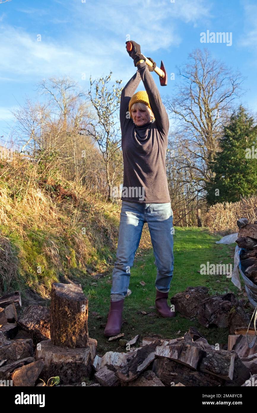 Woman chopping wood outdoors hi-res stock photography and images - Alamy