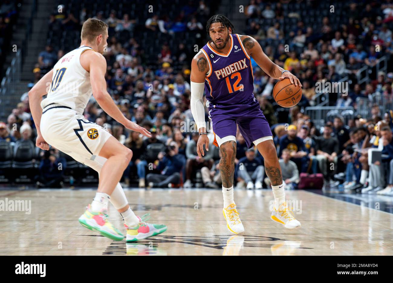 Phoenix Suns forward Ish Wainright, right, looks to drive past Denver ...