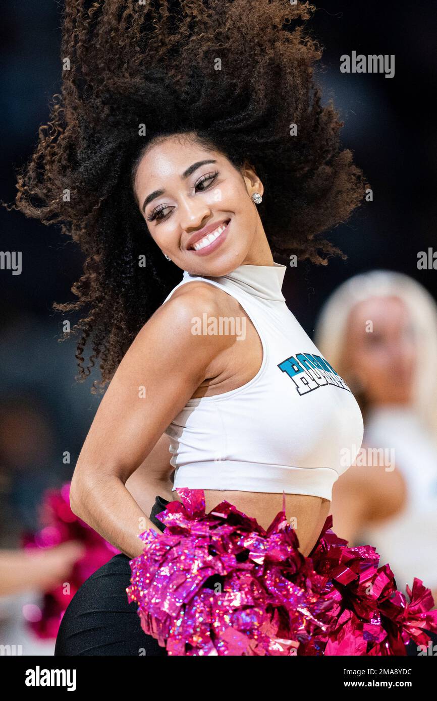 A Charlotte Hornets cheerleader and dancer performs during an NBA ...