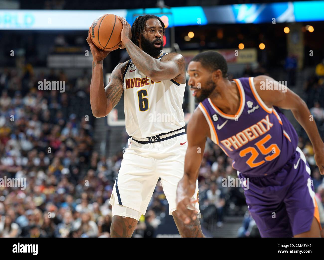 Denver Nuggets center DeAndre Jordan, left, pulls in a loose ball as ...