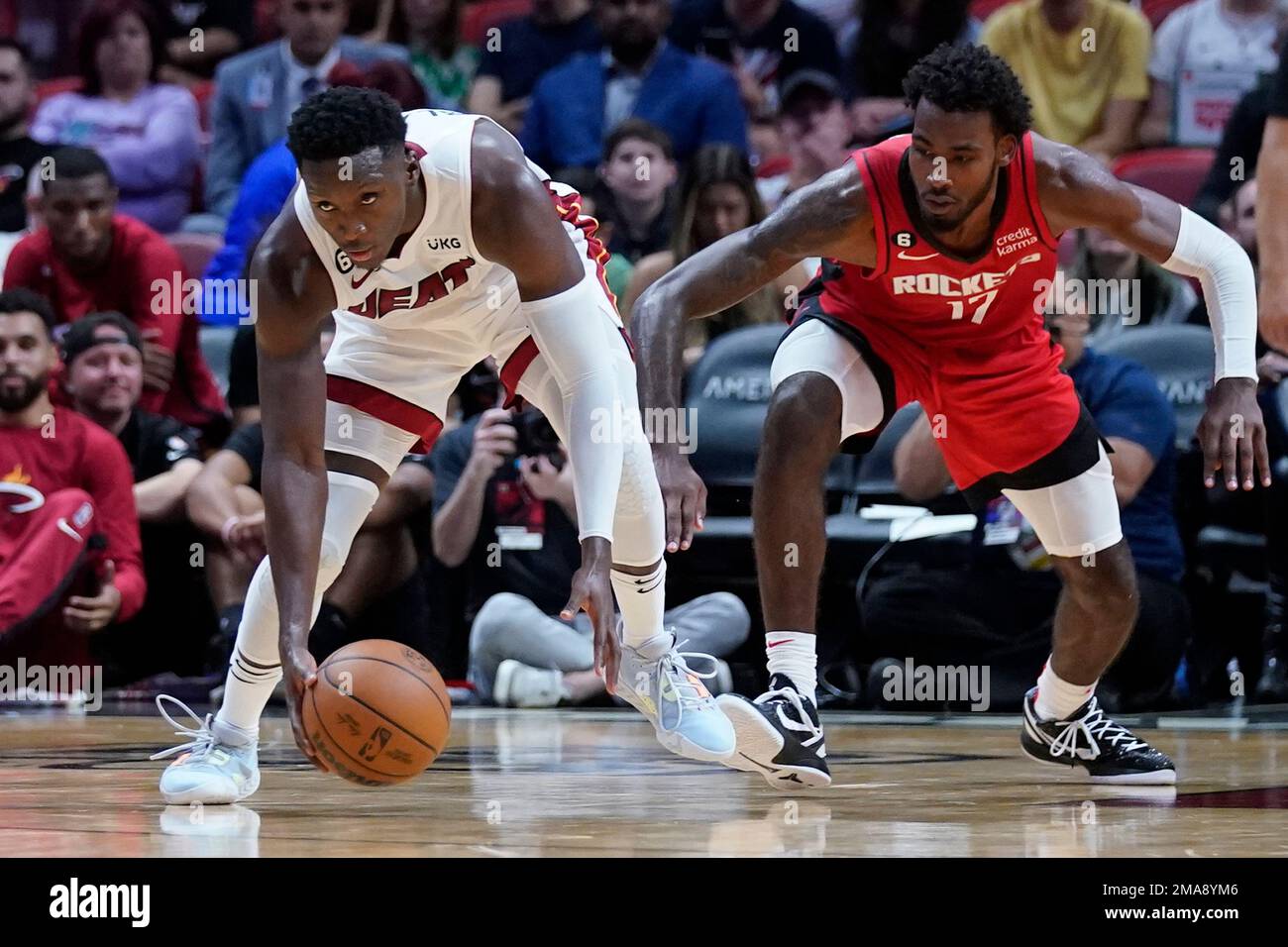 Miami Heat guard Victor Oladipo, left, picks up a loose ball against ...