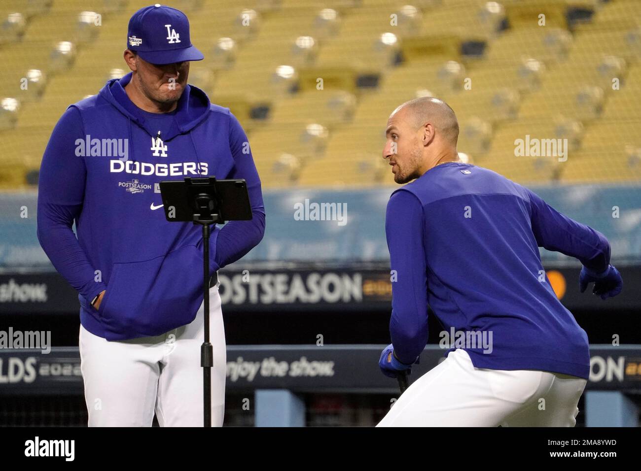 Los Angeles Dodgers' Trayce Thompson, right, speaks with a coach during ...
