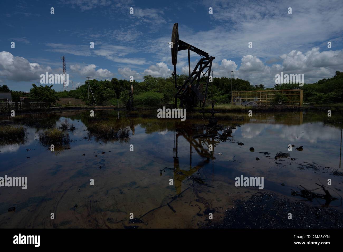 A broken oil well pollutes the water at a neighborhood in Cabimas ...