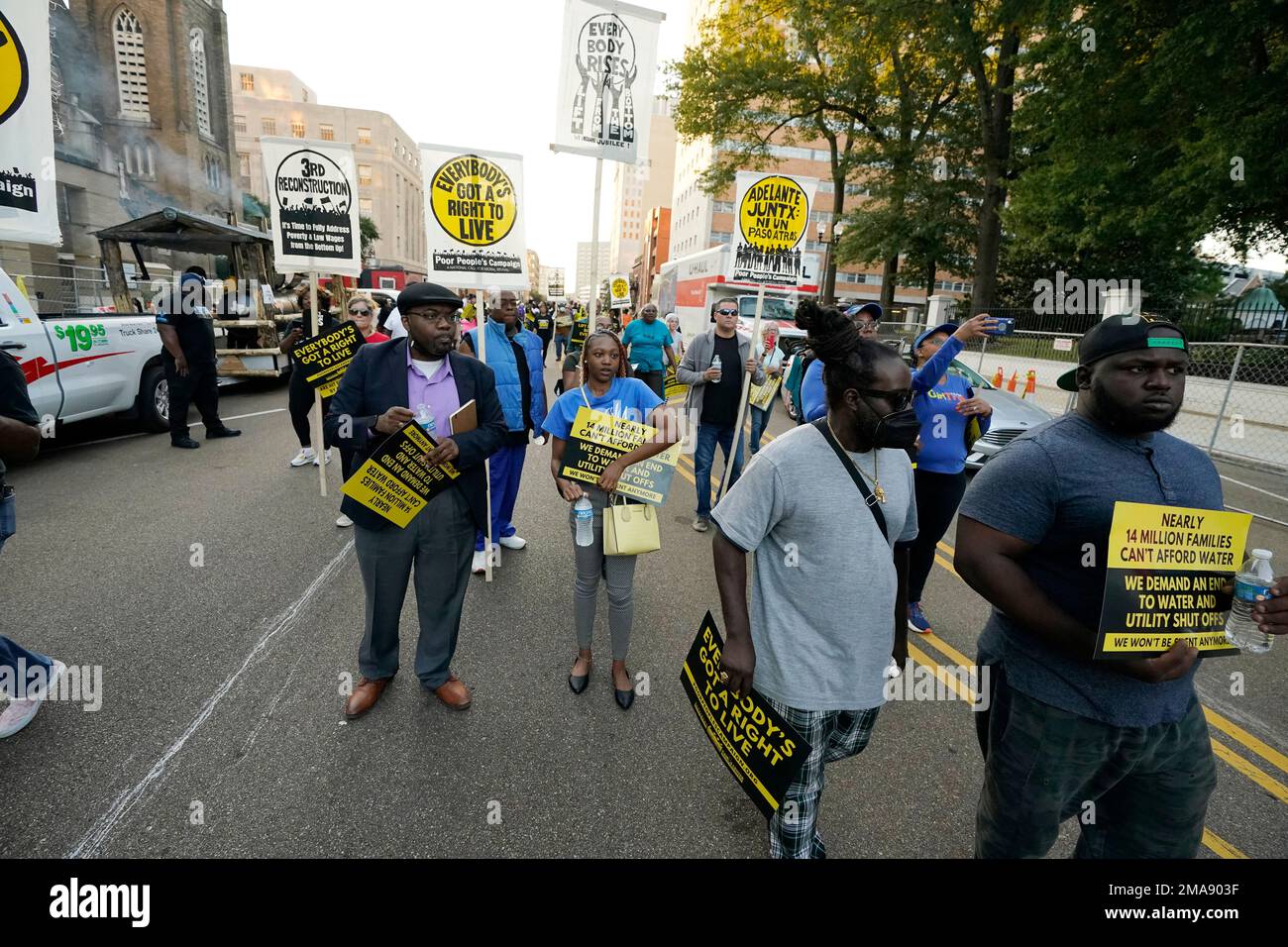 Jackson residents and supporters hold signs as they march to the ...
