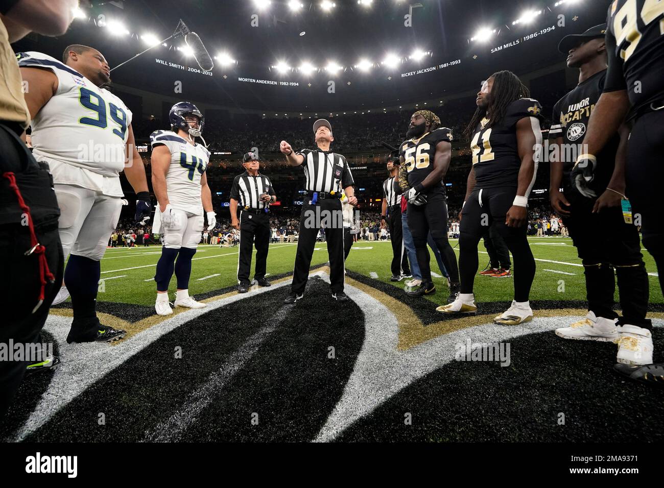 The referee performs the coin toss before an NFL football game between ...