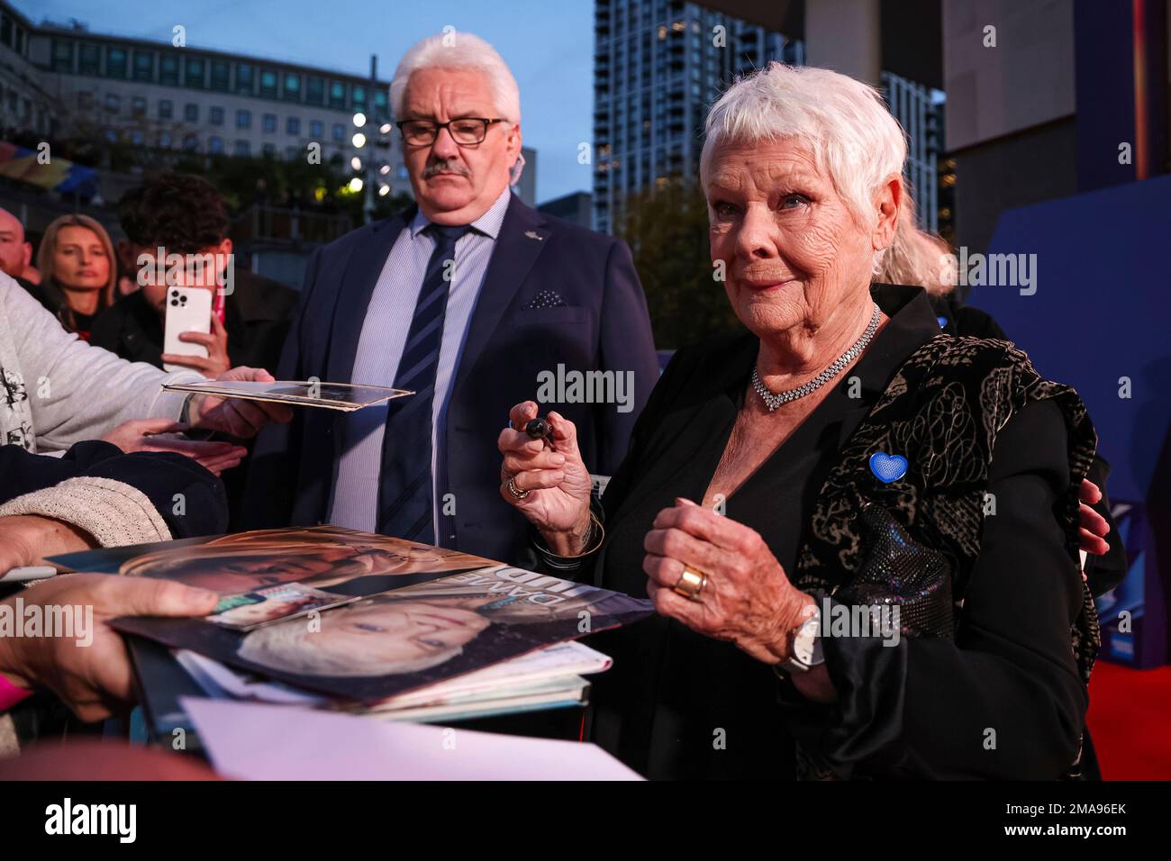 Judi Dench signs autographs upon arrival for the premiere of the film ...
