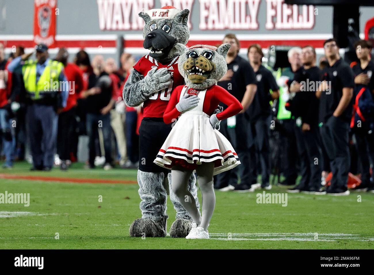Mr & Mrs Wuf stand doing the national anthem prior to the starts of an ...