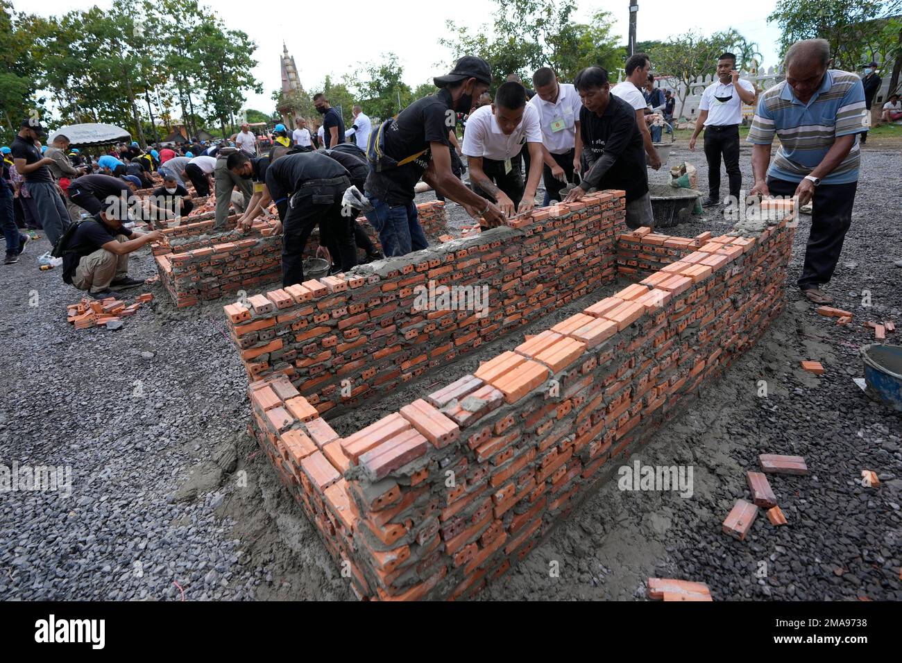 Locals lay bricks for cremation furnaces at Wat Rat Samakee temple in ...