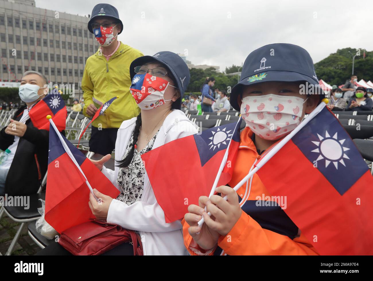 People wear masks patterned with the Taiwan national flag during ...