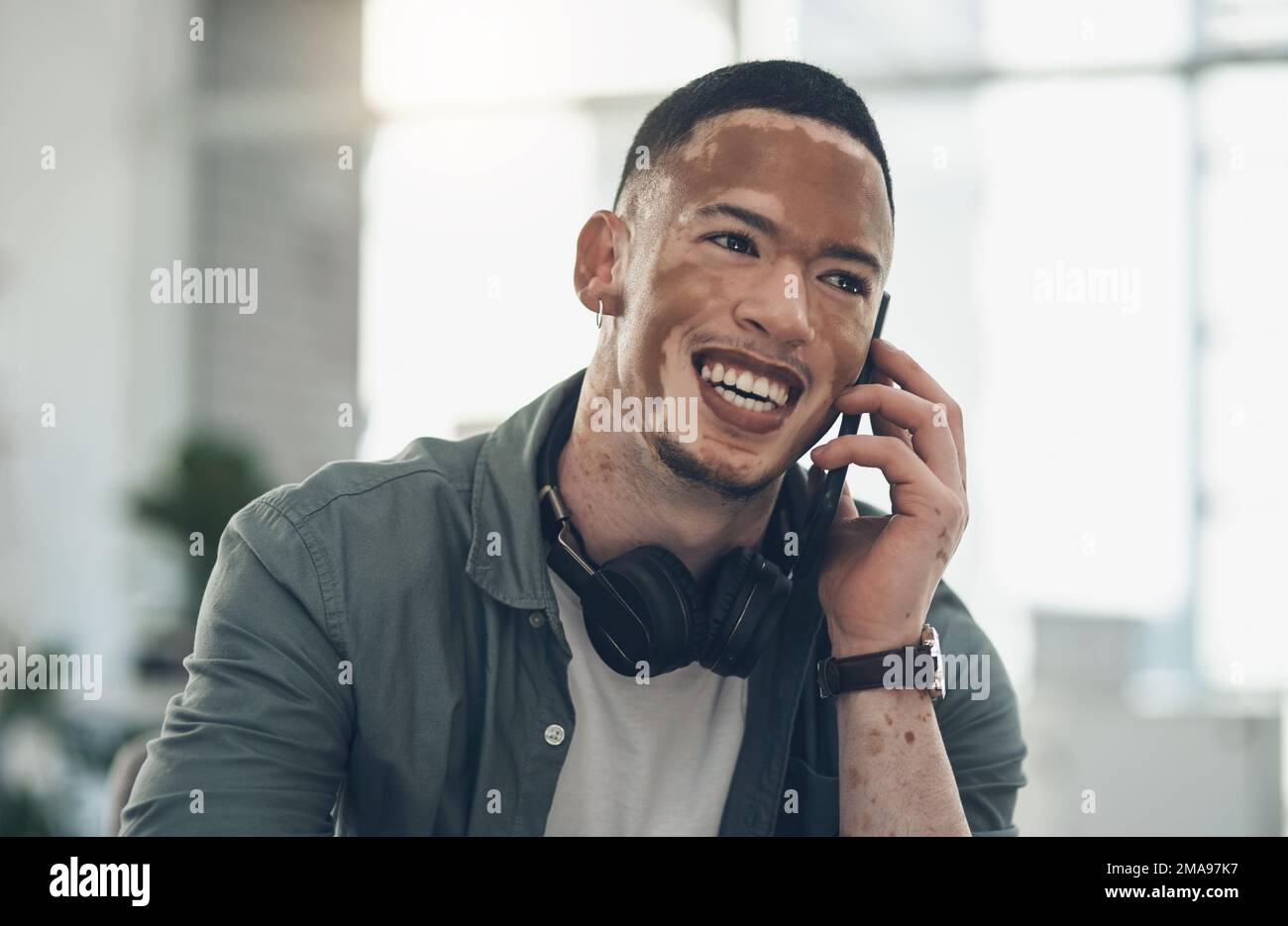 That Friday feeling. a young business man on a phone call in a modern ...