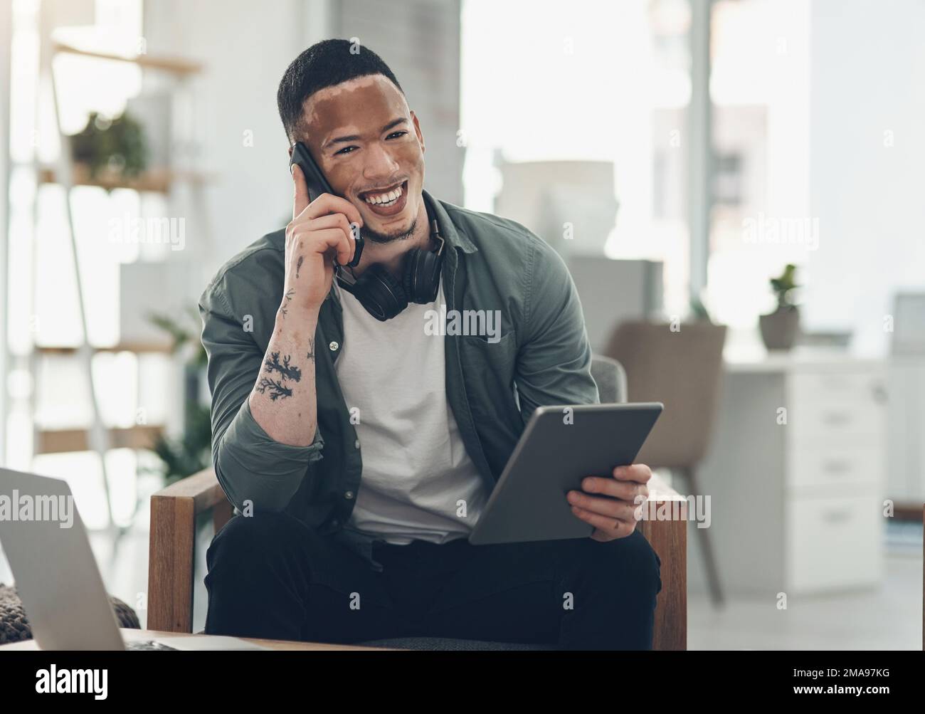 Happiness is the key to success. a young business man on a phone call ...