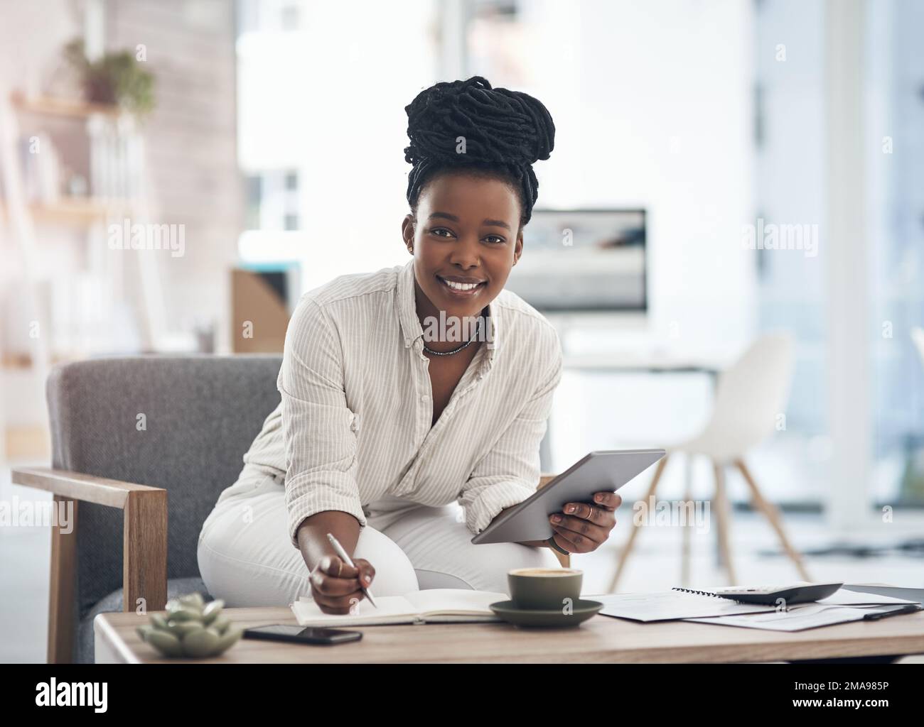 Making notes keeps me sharp. a businesswoman using her digital tablet ...