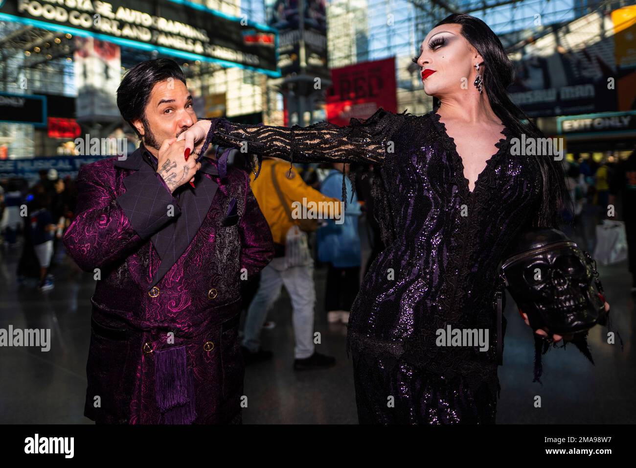 Attendees dressed as Gomez and Morticia Addams pose during New York ...