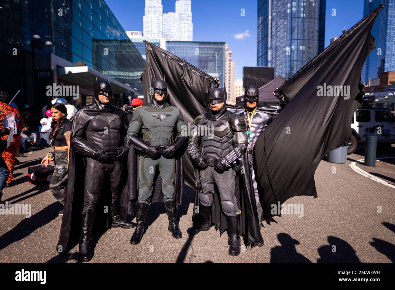 Attendees dressed as Batman pose during New York Comic Con at the Jacob ...