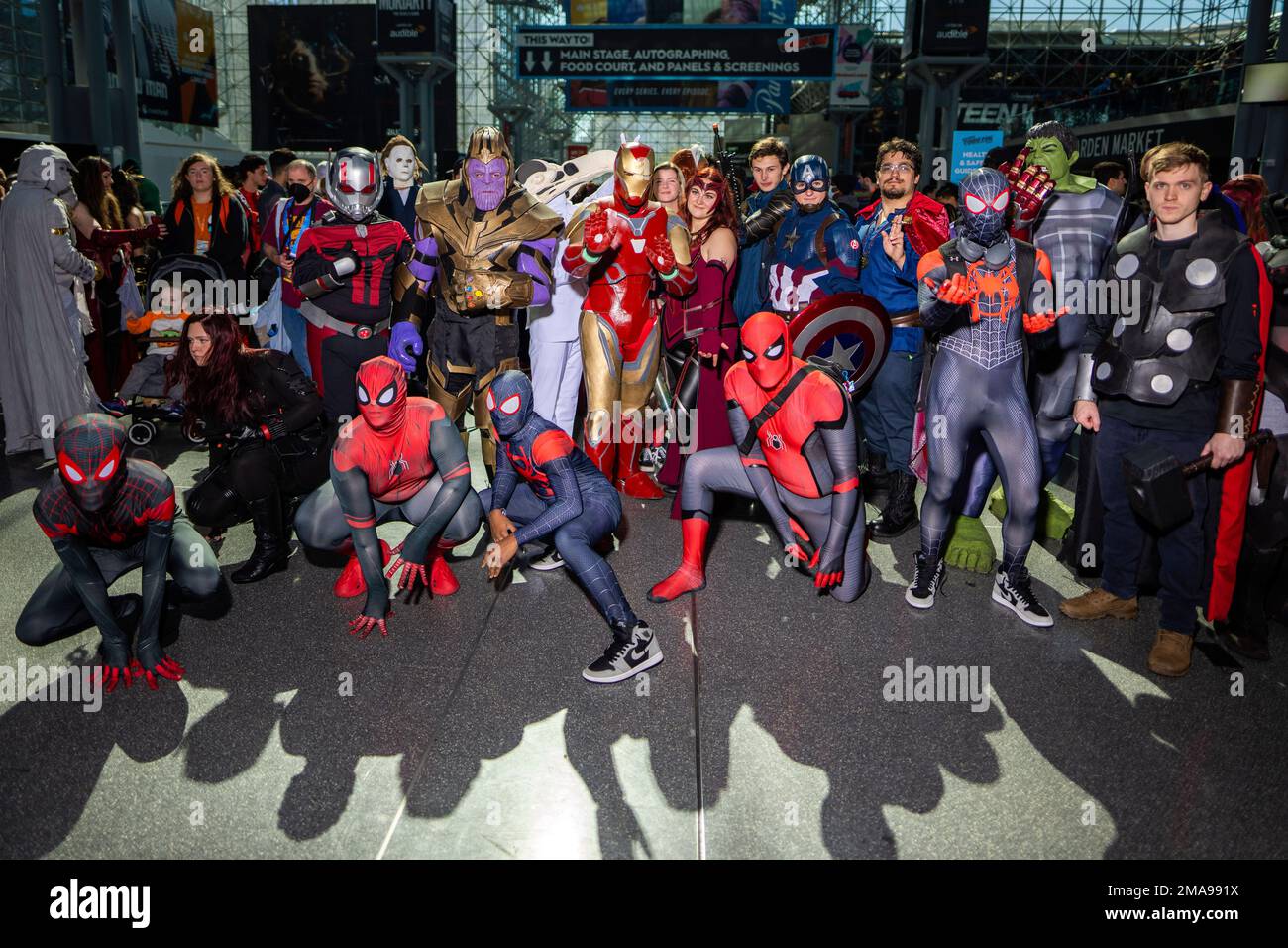 Attendees dressed as Marvel superheroes pose during New York Comic Con ...