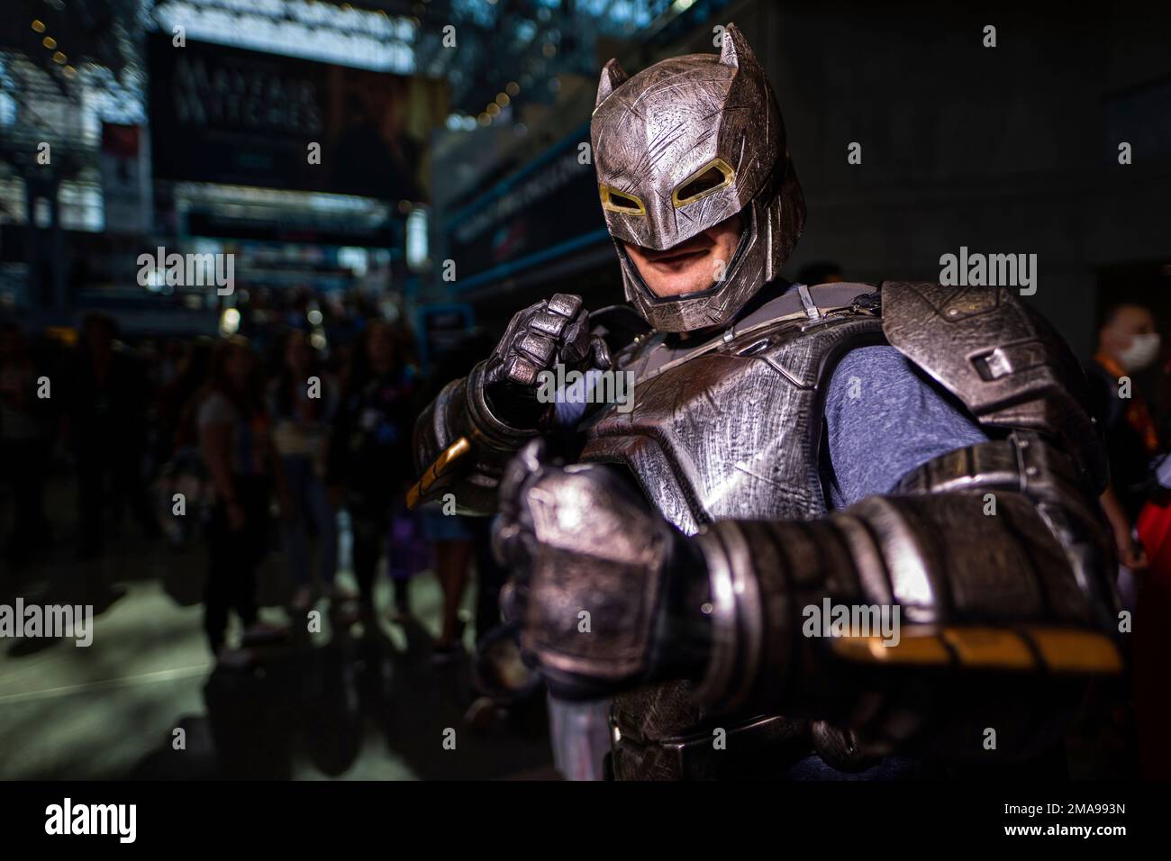 An attendee dressed as Batman poses during New York Comic Con at the ...