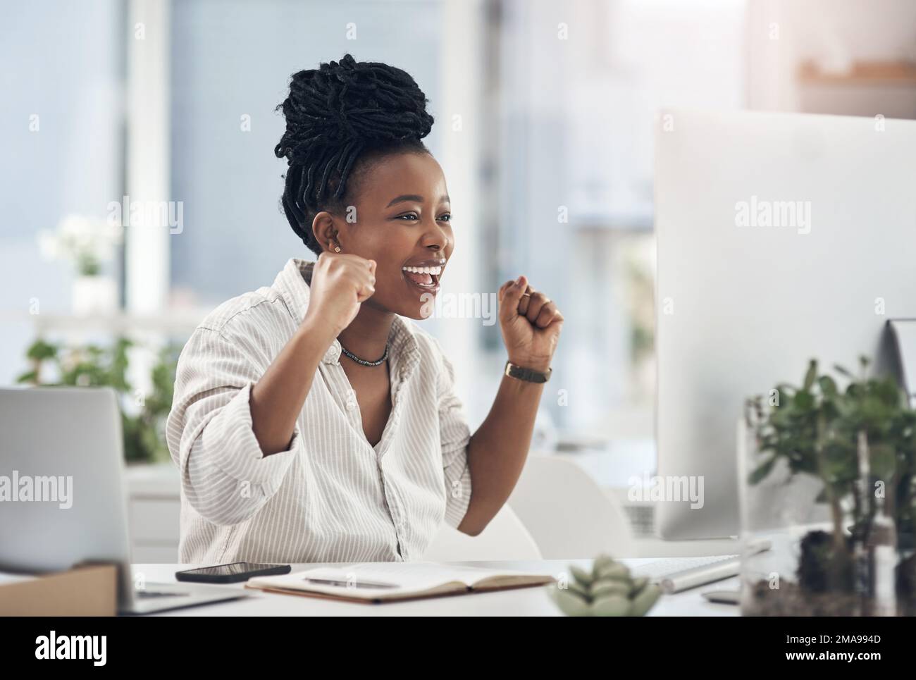 My hard work has finally paid off. a young business celebrating by ...