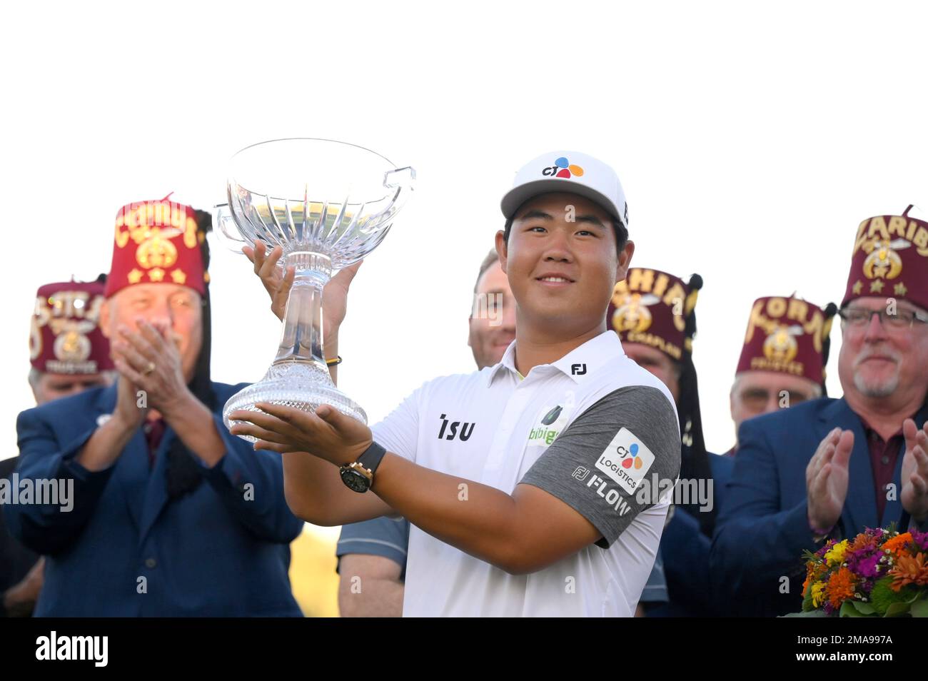 Tom Kim, of South Korea, displays the trophy after winning the Shriners ...