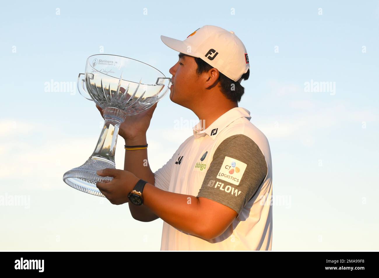 Tom Kim, of South Korea, kisses the trophy after winning the Shriners ...