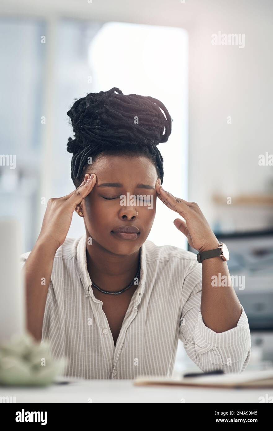 Ive pushing myself too hard lately. a young businesswoman experiencing ...