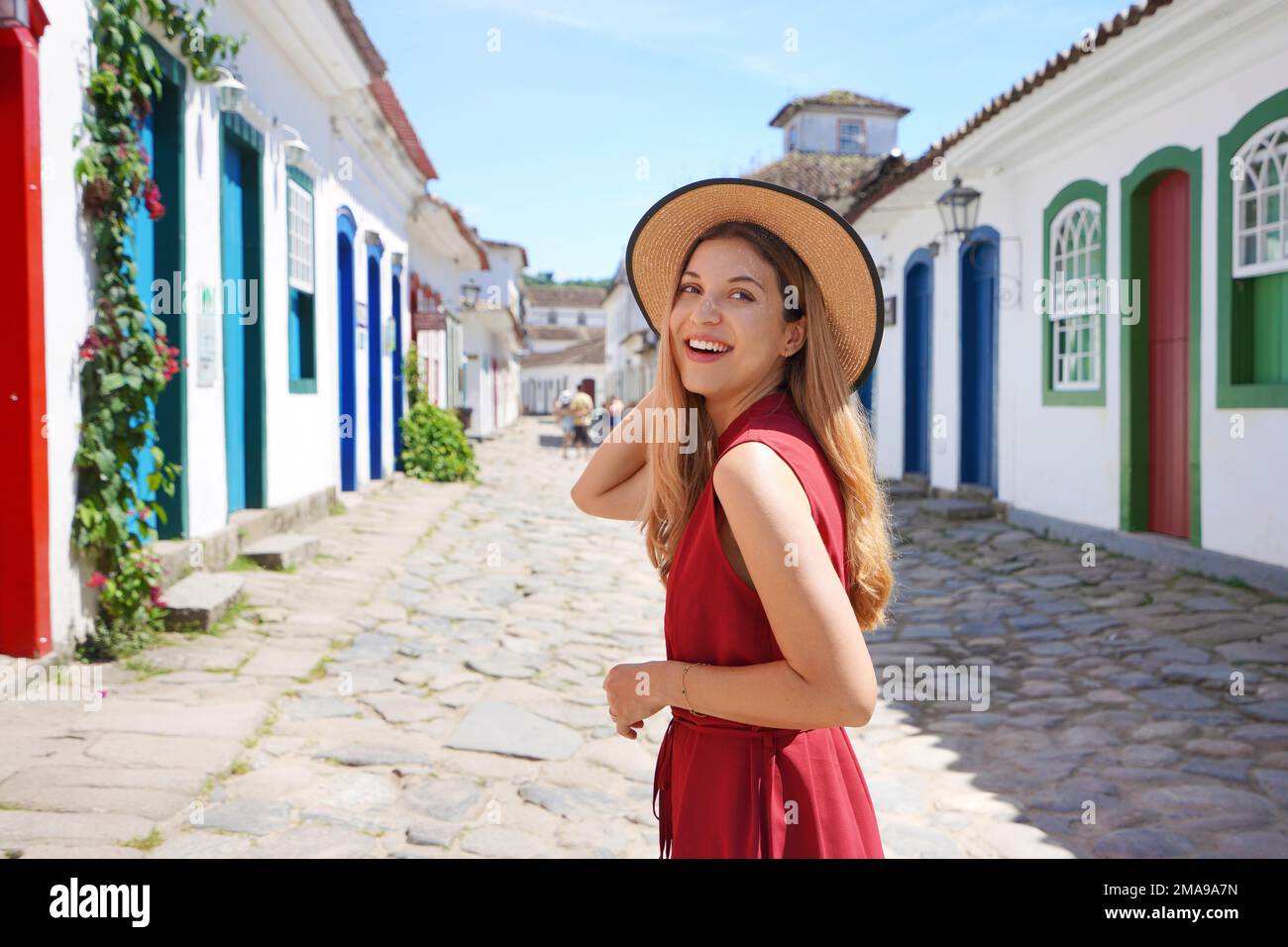 Attractive excited tourist woman turns around and looking behind ...