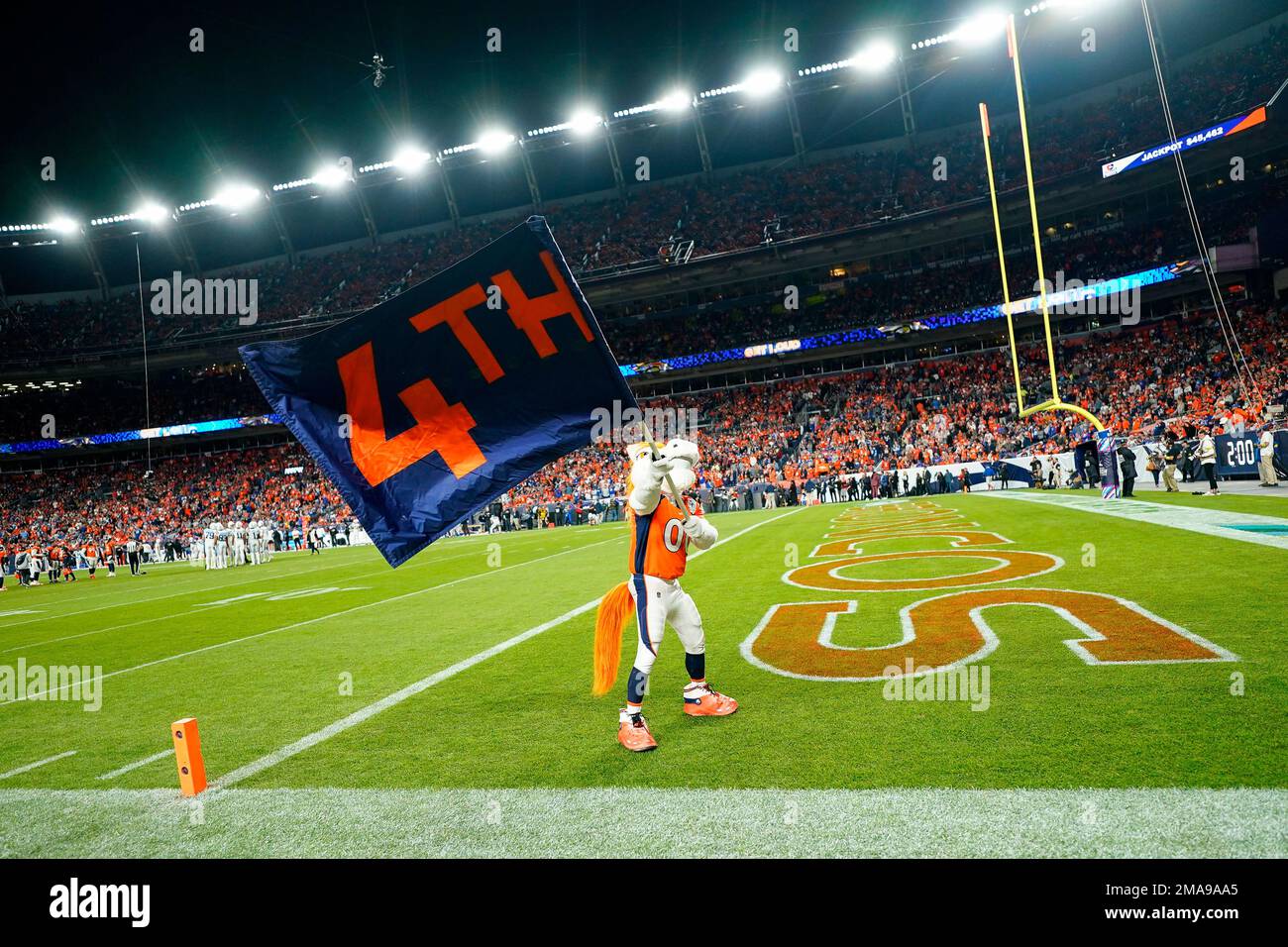 Denver Broncos mascot Miles holds up a fourth quarter flag against the ...