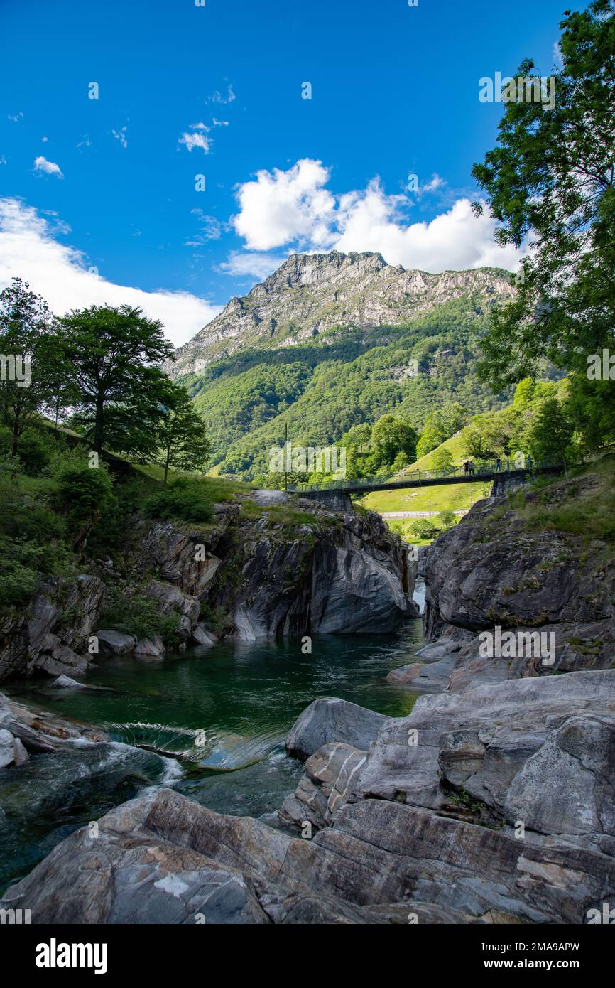 Landscape shot of a stream with bridge and mountains Stock Photo - Alamy