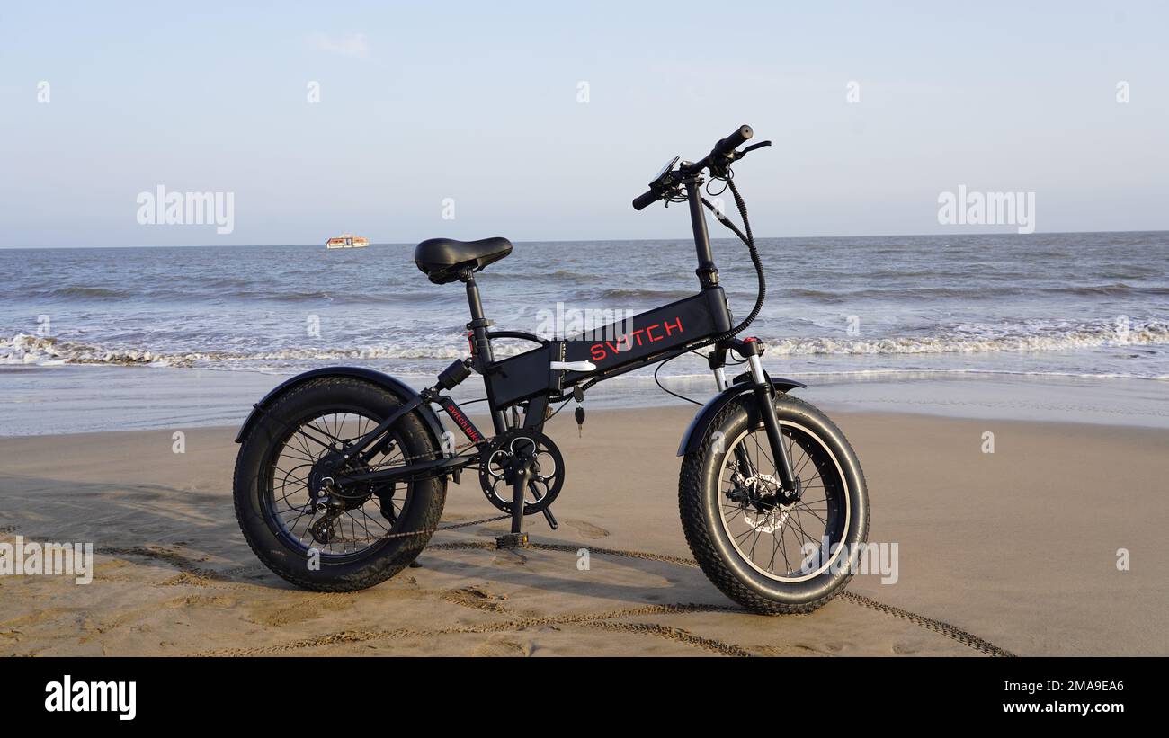 Black E-bike on sea shore Stock Photo - Alamy