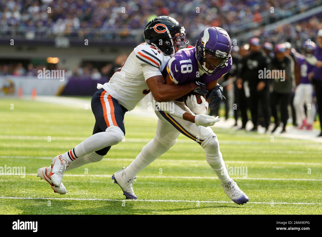 Minnesota Vikings wide receiver Justin Jefferson (18) tries to break a tackle by Chicago Bears ...