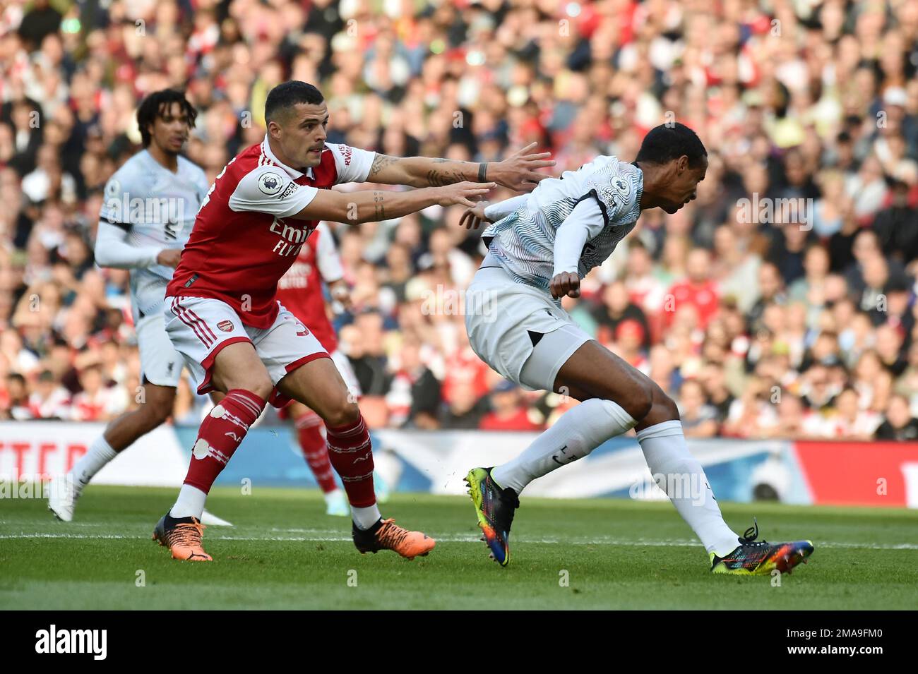 Arsenal's Reiss Nelson, left, challenges for the ball with Liverpool's ...