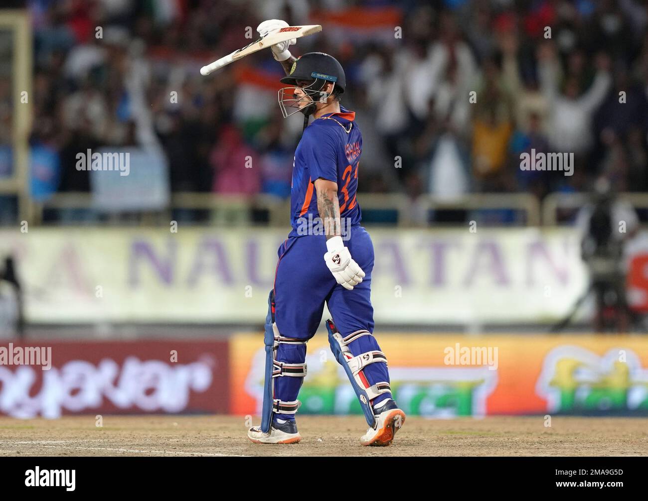 India's Ishan Kishan raises his bat to celebrate his half century ...