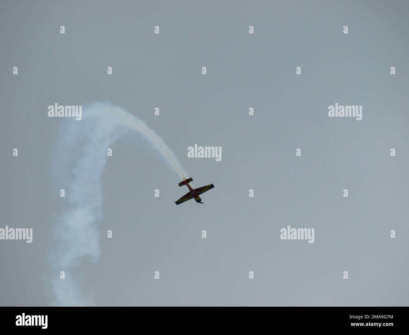 Light aircraft performing acrobatic aerobatic flying during air show ...