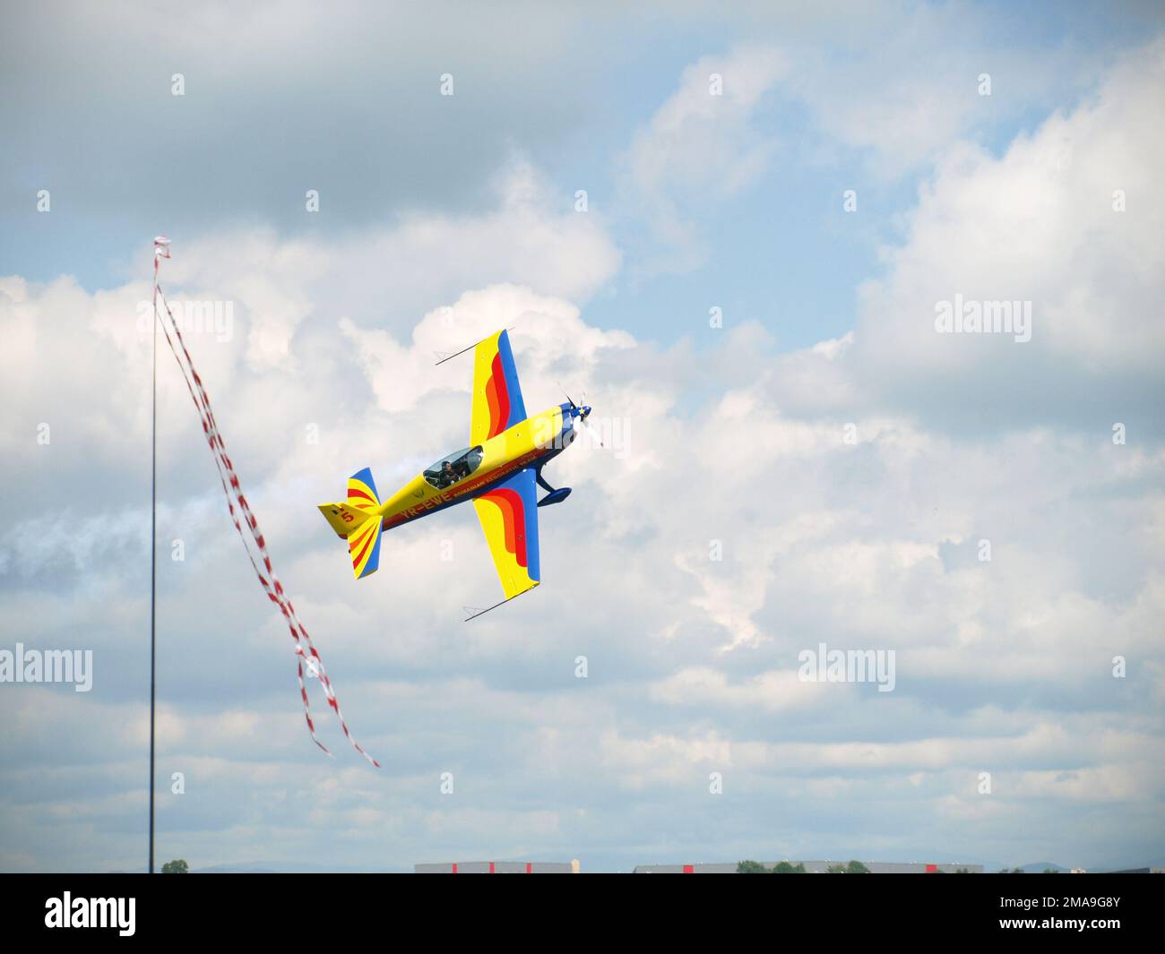 Light aircraft performing acrobatic aerobatic flying during air show ...